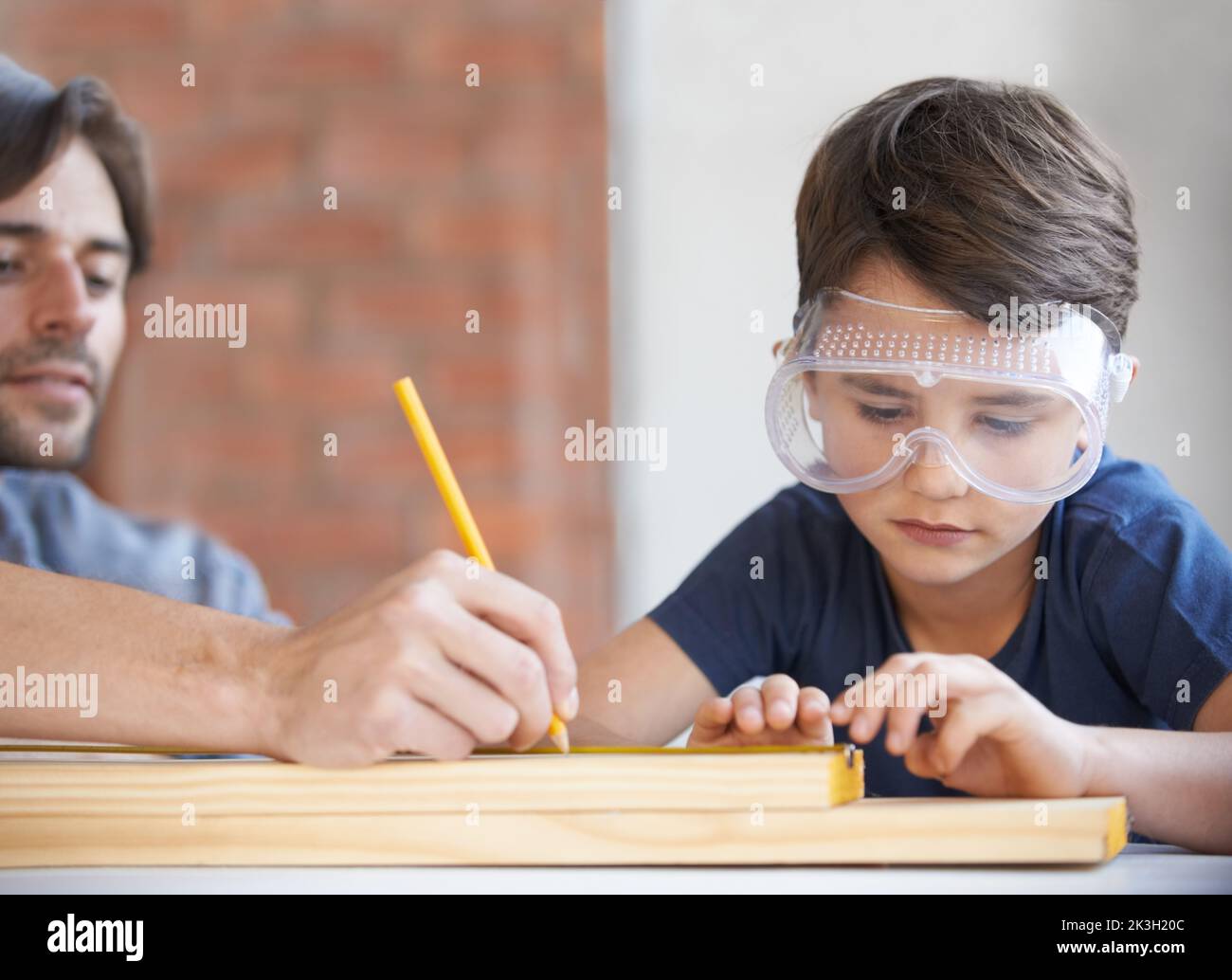 Teaching his son about the ins and outs of carpentry. A father and son ...
