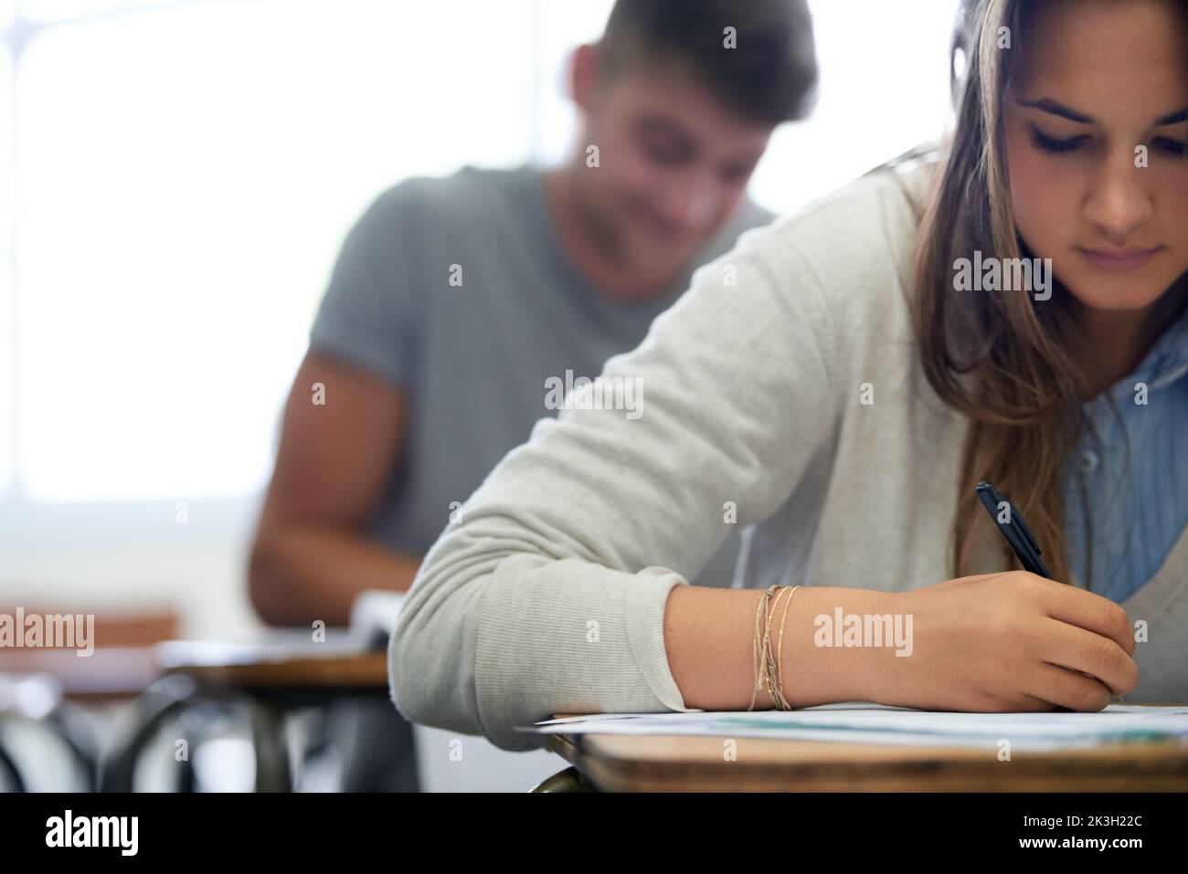 Working towards their future. young college students hard at work in ...