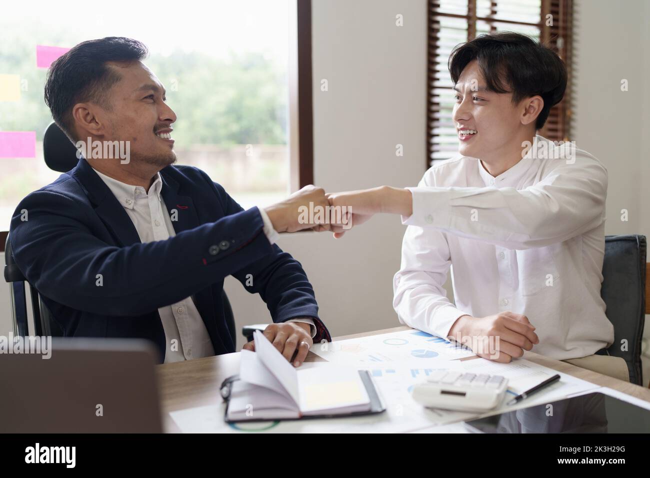 Group of business people putting their hands working together on wooden ...
