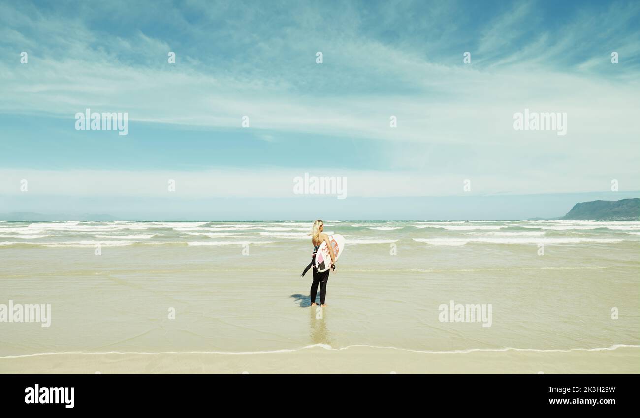 On Her Way Into The Ocean A Young Surfer Girl Holding Her Surfboard