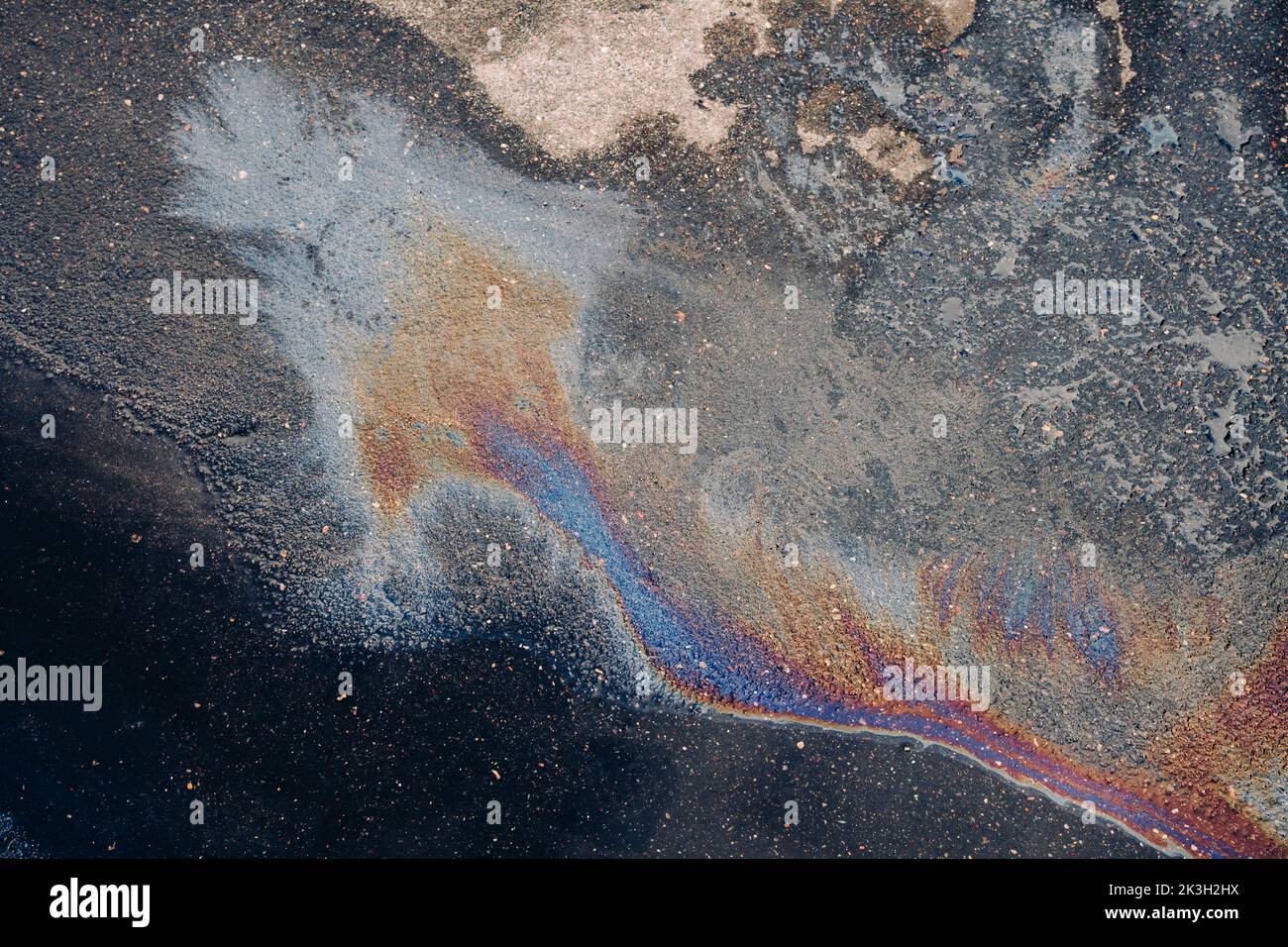 Dirty multi-colored stain from engine oil on asphalt. Environmental ...