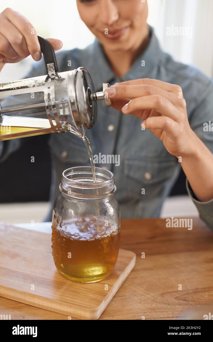 Plunger preparation. Woman using a plunger to prepare a beverage Stock ...