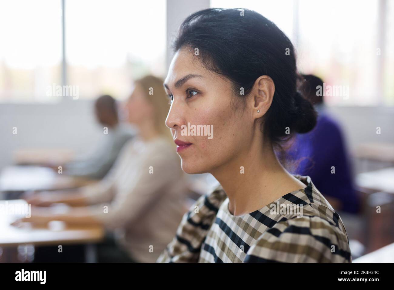Focused japanese woman listening lecture at adult education class Stock ...