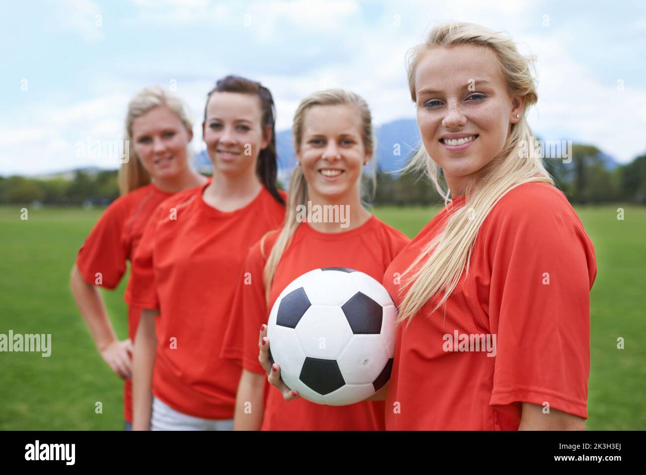 Shell lead the team to victory. Portrait of a young female soccer ...