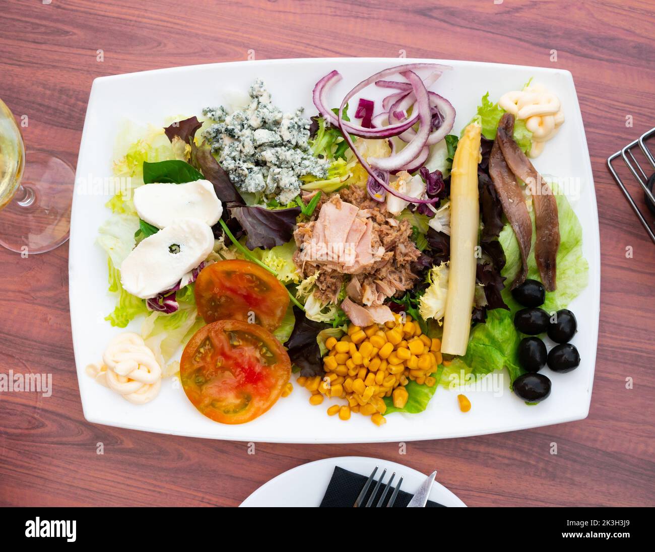 Appetizing salad with tuna, cheese, corn and olives Stock Photo - Alamy
