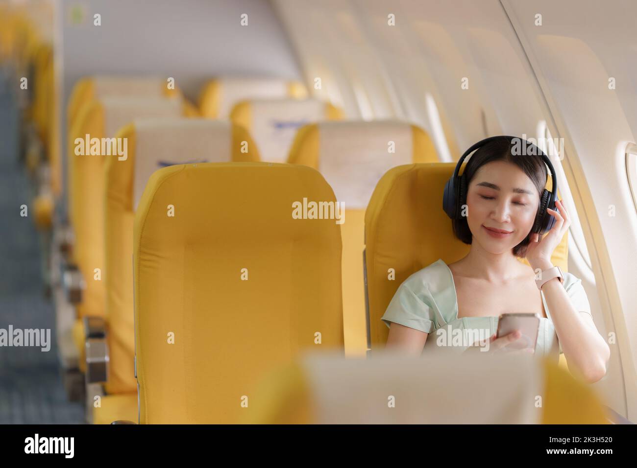 Young asian woman using smartphone connected to wifi internet during ...