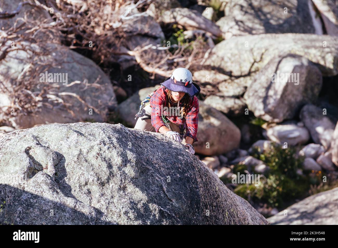 A rock climber tackles a steep incline on Mt Buffalo on a summer's ...