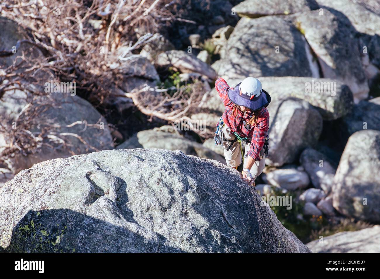 A rock climber tackles a steep incline on Mt Buffalo on a summer's ...