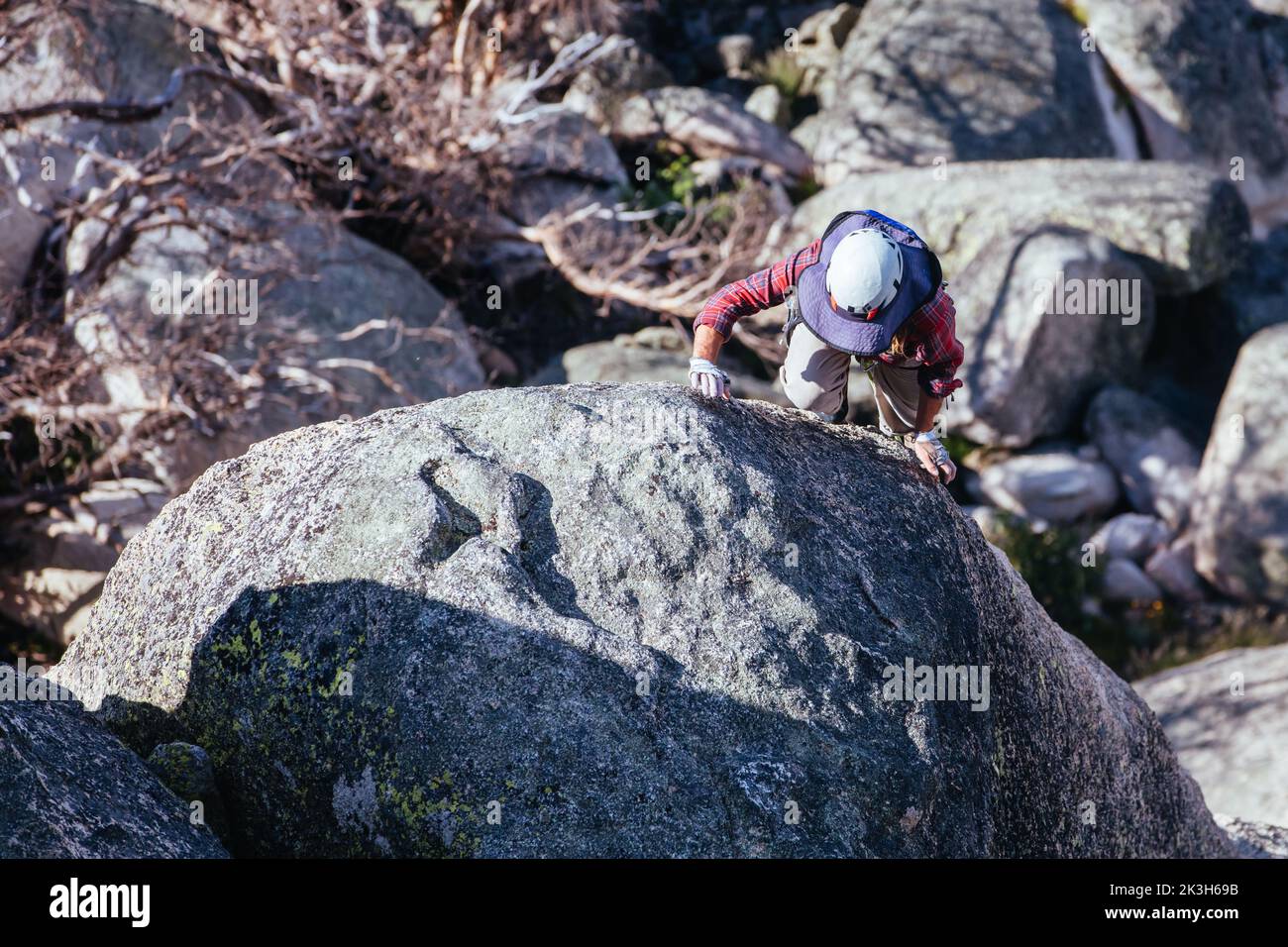 A rock climber tackles a steep incline on Mt Buffalo on a summer's ...