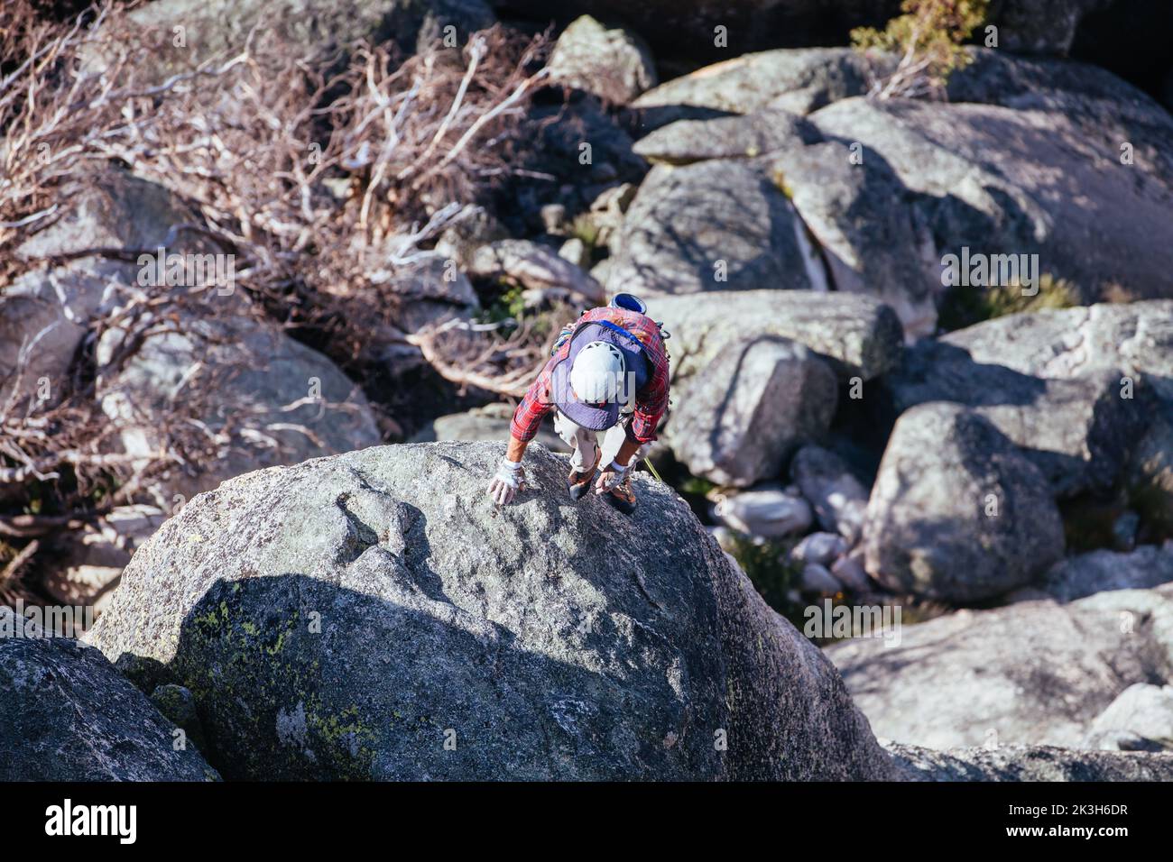 A rock climber tackles a steep incline on Mt Buffalo on a summer's ...