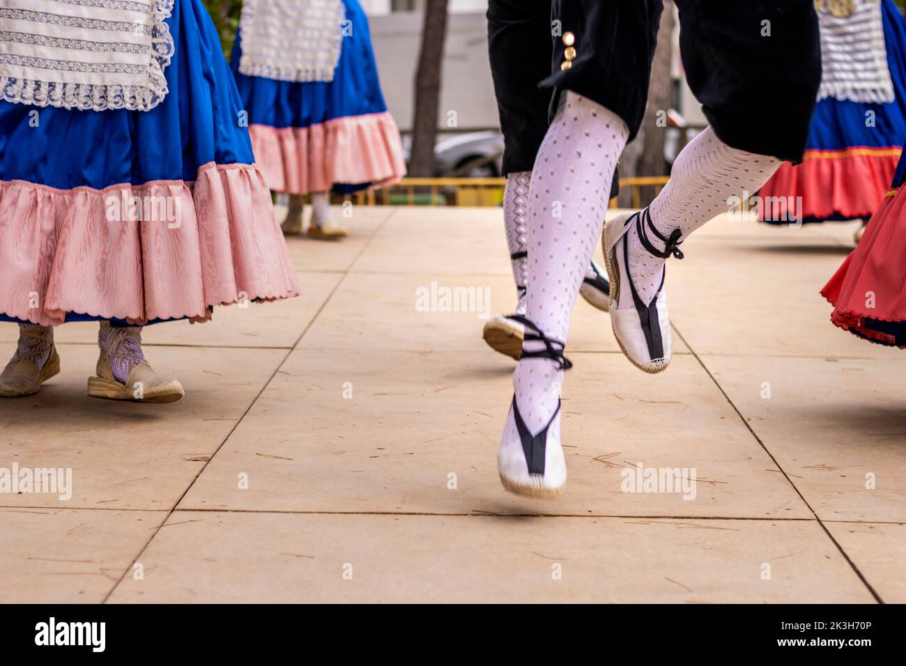 Spanish people wearing traditional clothes dancing Stock Photo - Alamy