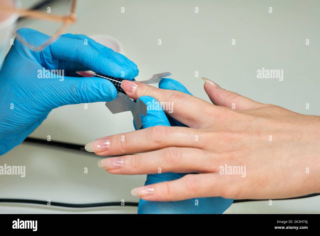 Beauty nails construction. Lower nail extensions. Master manicurist in ...