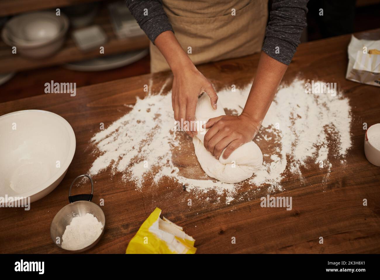 Making her own bread. A young female baker with homemade bread Stock ...