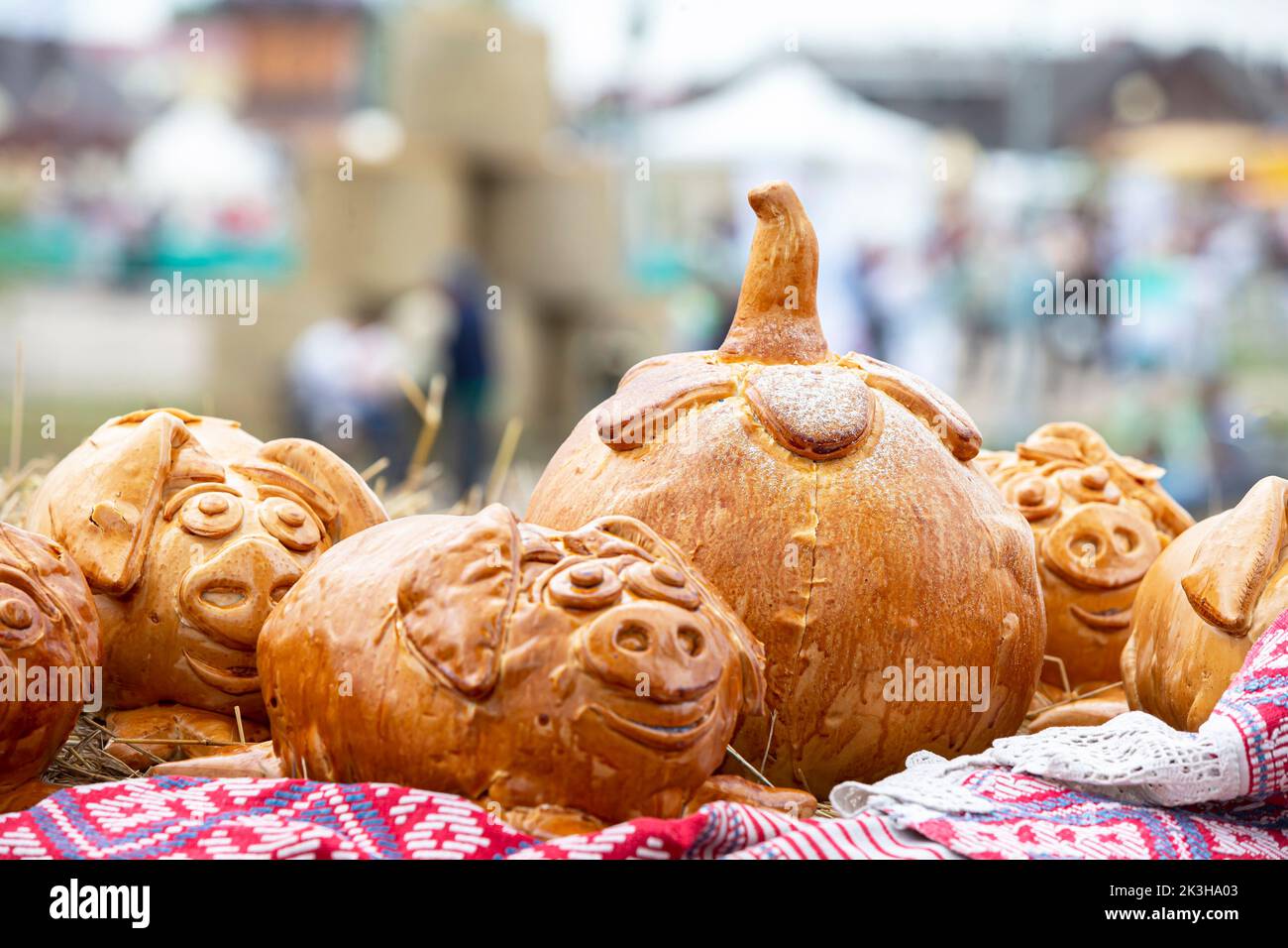 Rural autumn fair. Halloween pastries. Buns in the form of a pumpkin ...
