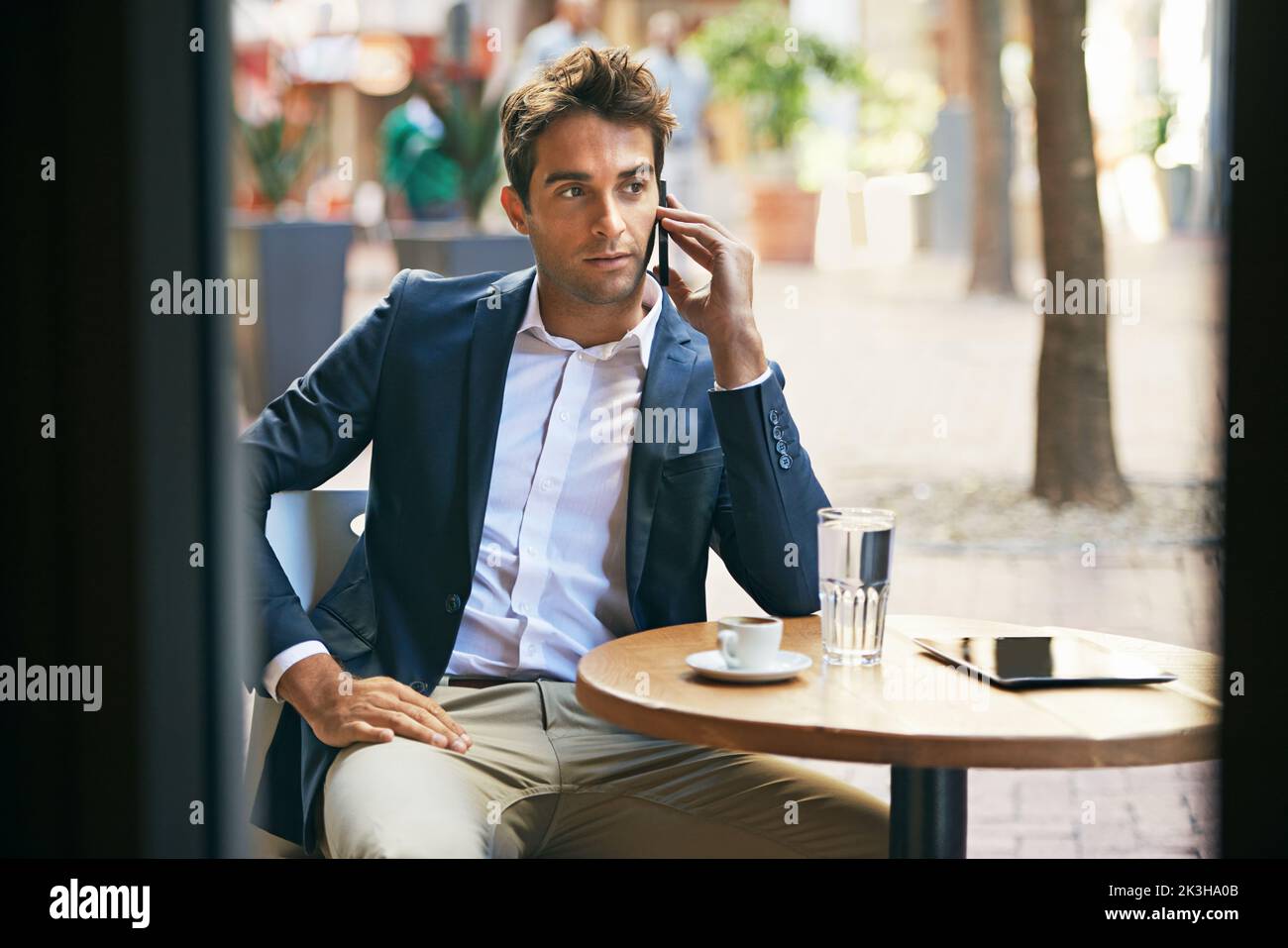 Always available to his clients. A young businessman talking on his ...