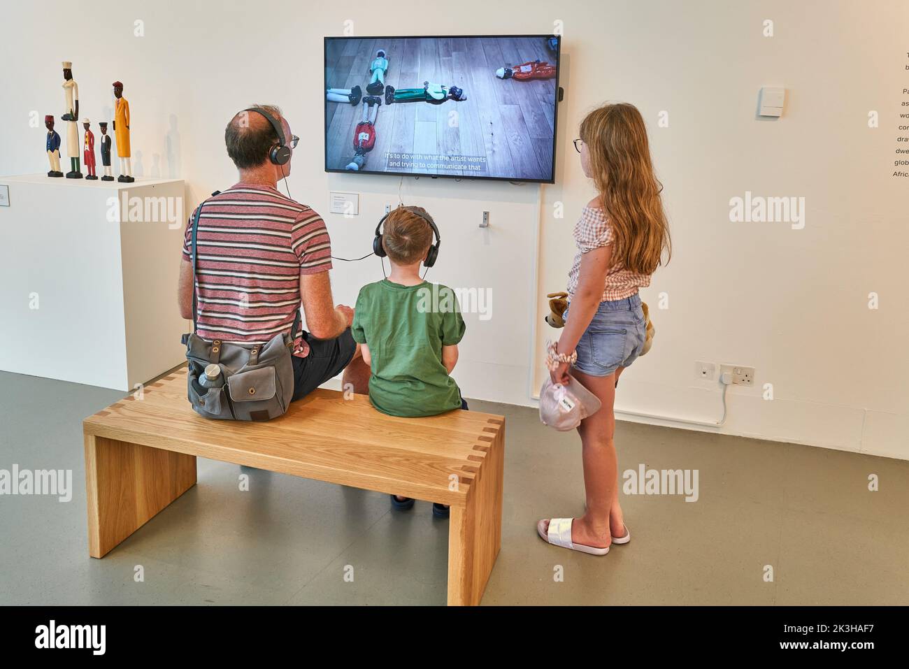 A father, son and daughter watch an audio visual exhibition at the ...