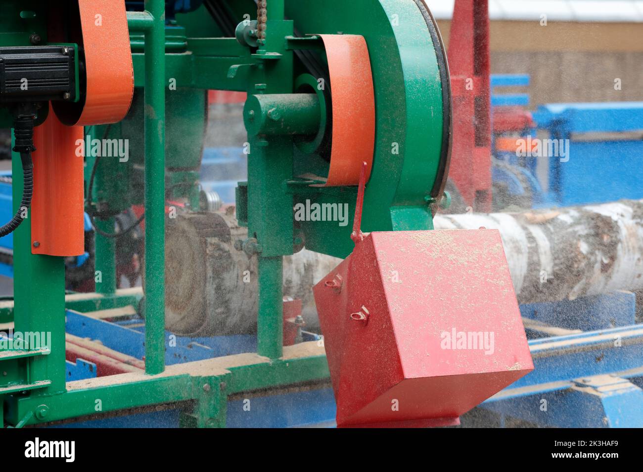 Log cutting with band saw machine at sawmill. Selective focus Stock ...