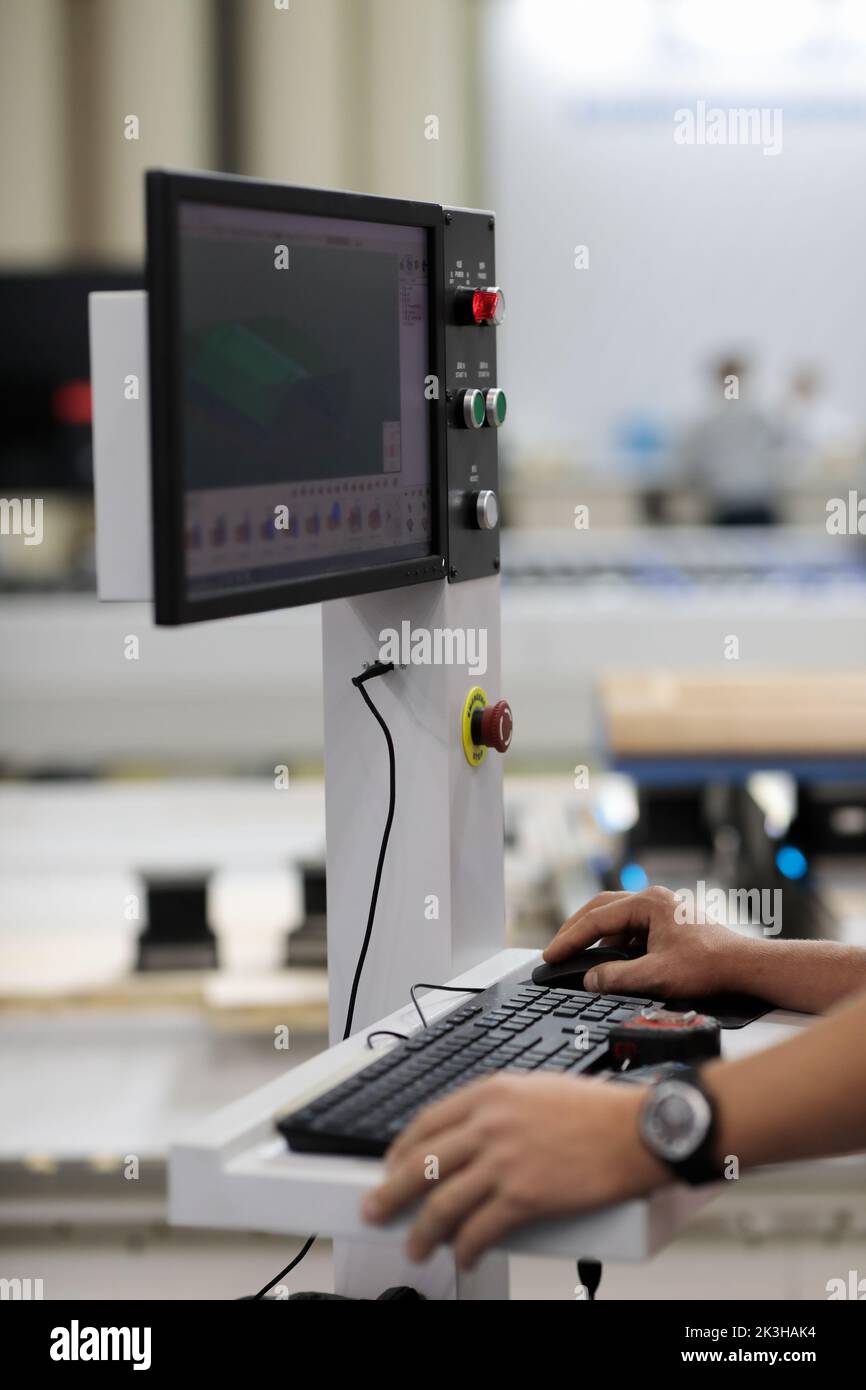 Operator controls computerized industrial machine. Selective focus ...