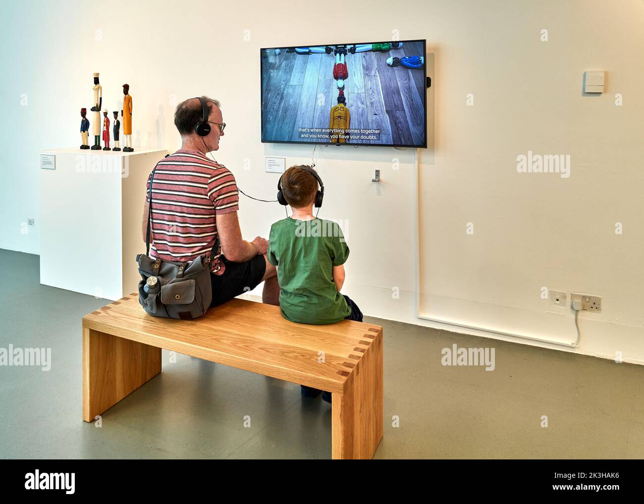 A father and his son watch an audio visual exhibition at the National ...