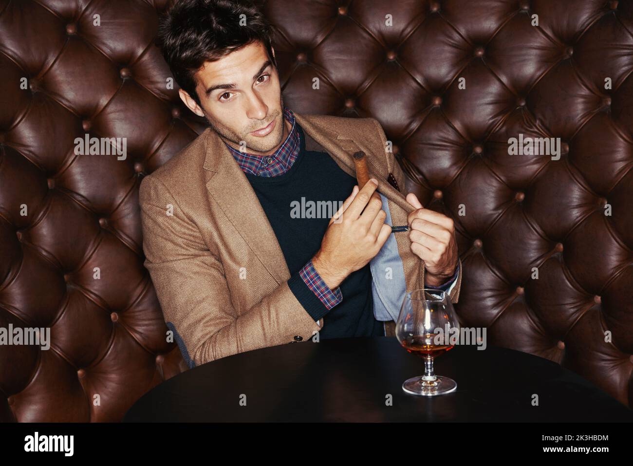 I love a good cigar. A handsome young man with a cigar drinking in a ...