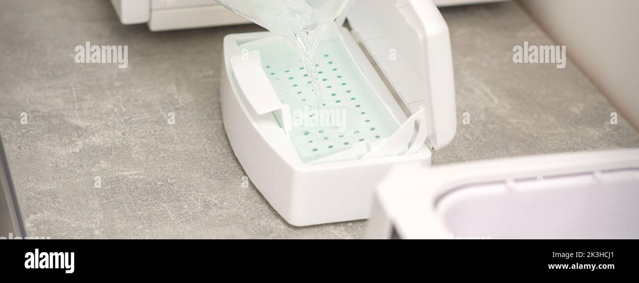 Adding liquid for disinfection of instruments to the machine for ...