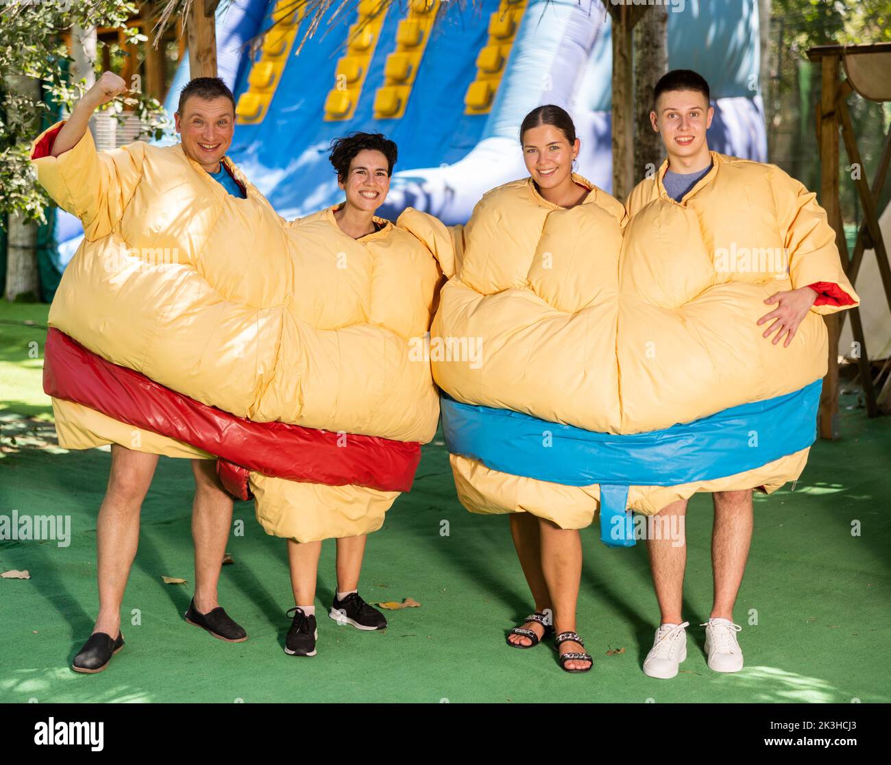 Group photo of smiling men and women wearing funny sumo suits Stock ...