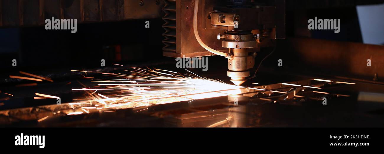 Sparks fly out of automated machine, metal processing laser on ...