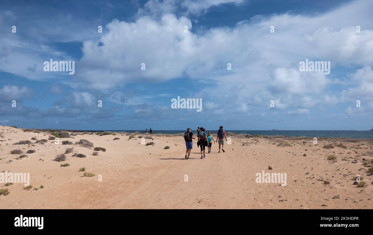 Group of friends hiking along the virgin beaches on the island of La ...