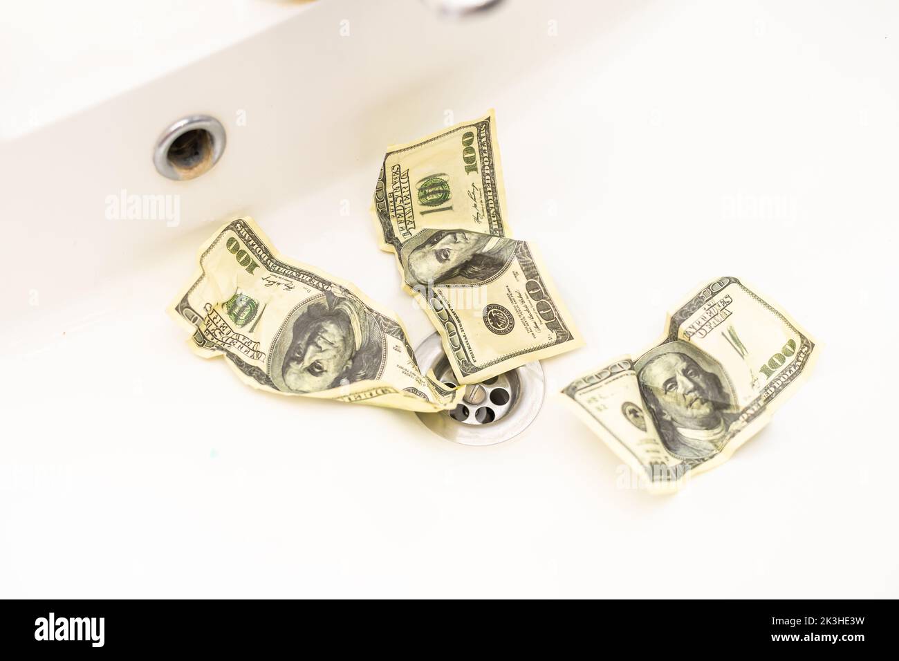 Money down the drain metaphor hi-res stock photography and images - Alamy