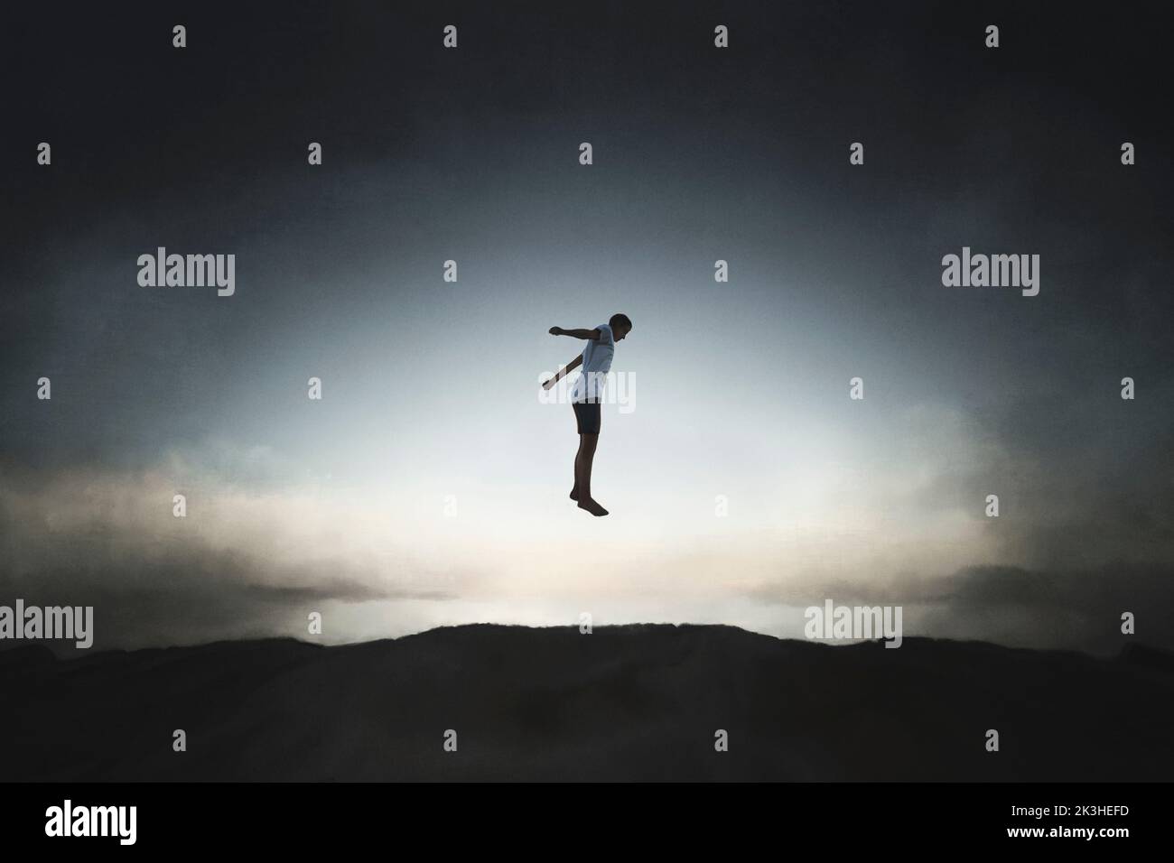 silhouette of a happy boy jumping almost touching the sky, concept of ...