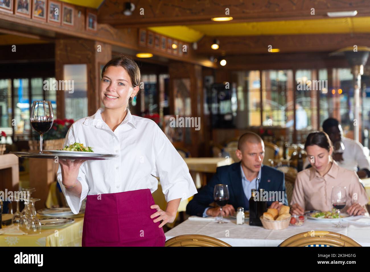 Waiter standing with serving tray, recommending dishes in restaurant ...