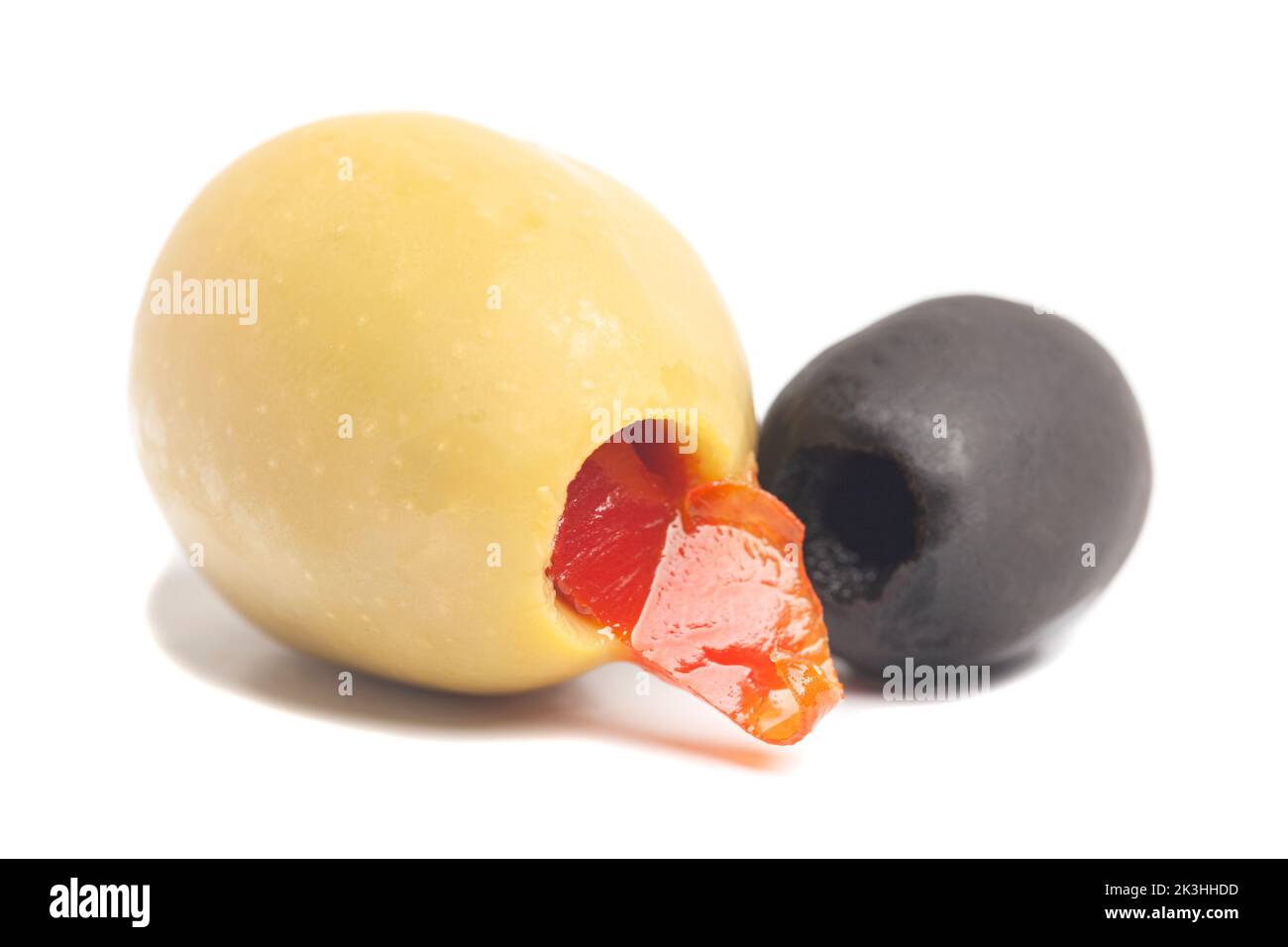 Green olives stuffed with sweet peppers and black olives isolated on a ...