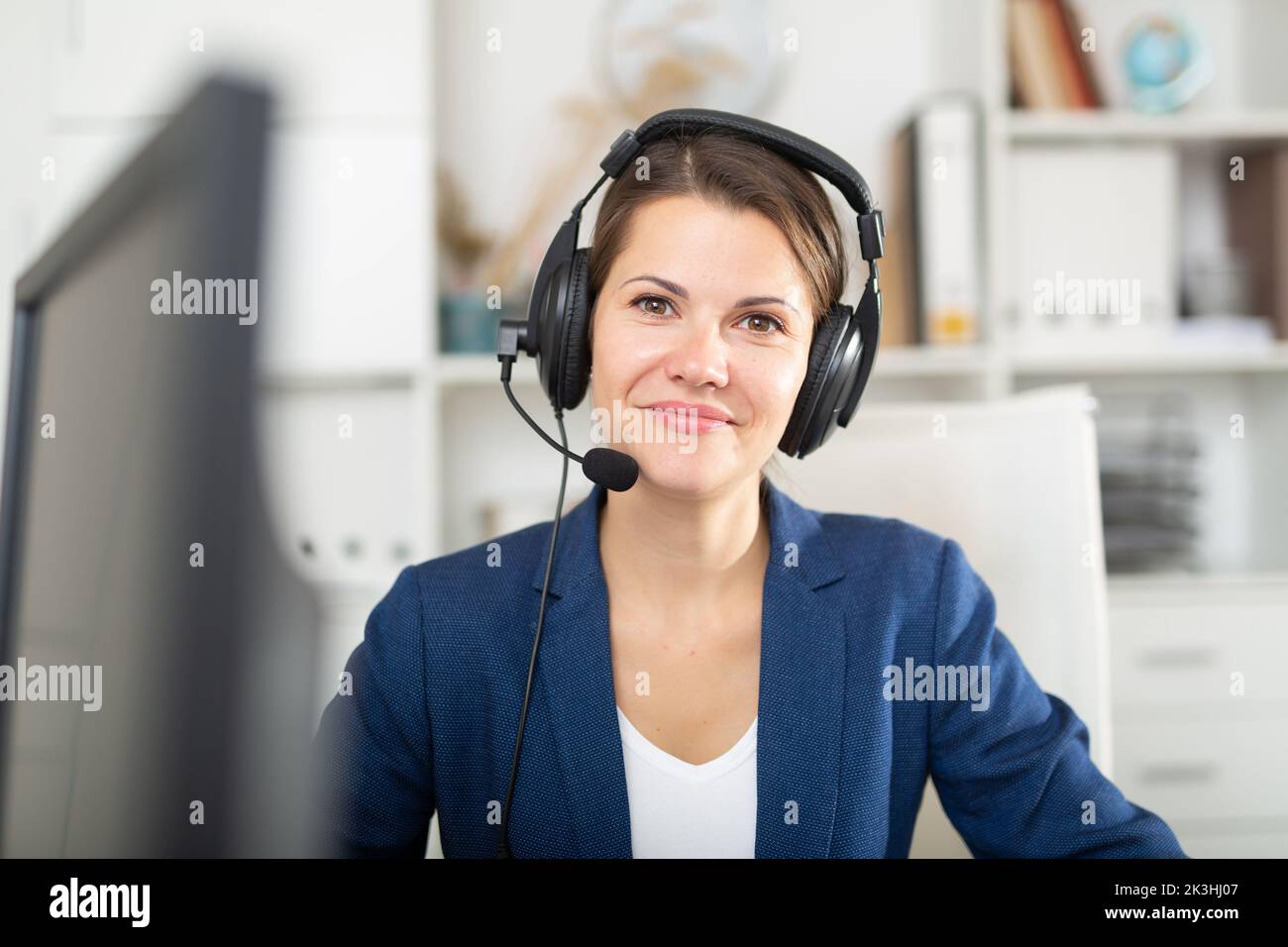 Portrait of smiling woman helpline operator with headphones Stock Photo ...