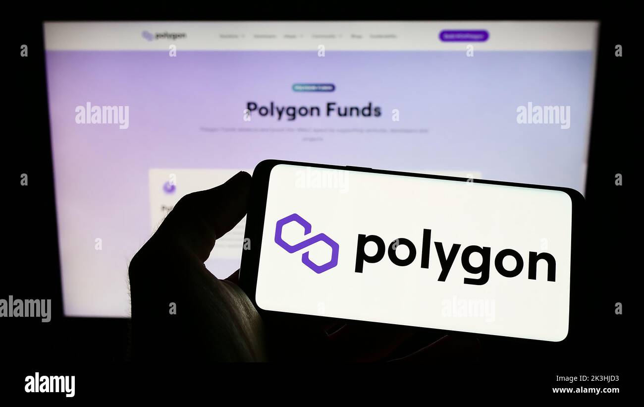 Person holding cellphone with logo of Indian Web3 company Polygon Technology on screen in front ...