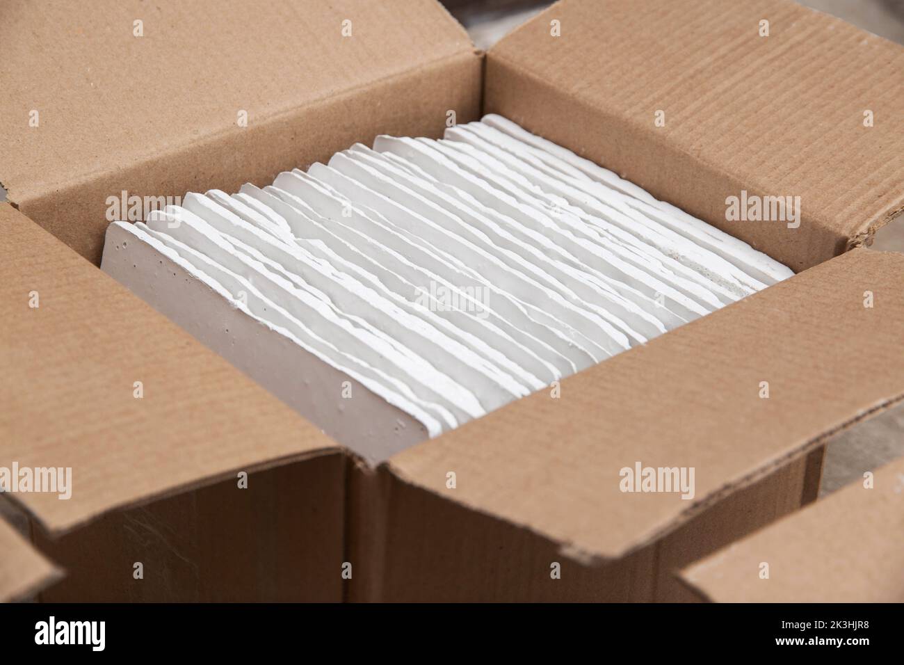 Cardboard box with a decorative stone made of plaster in the form of a ...