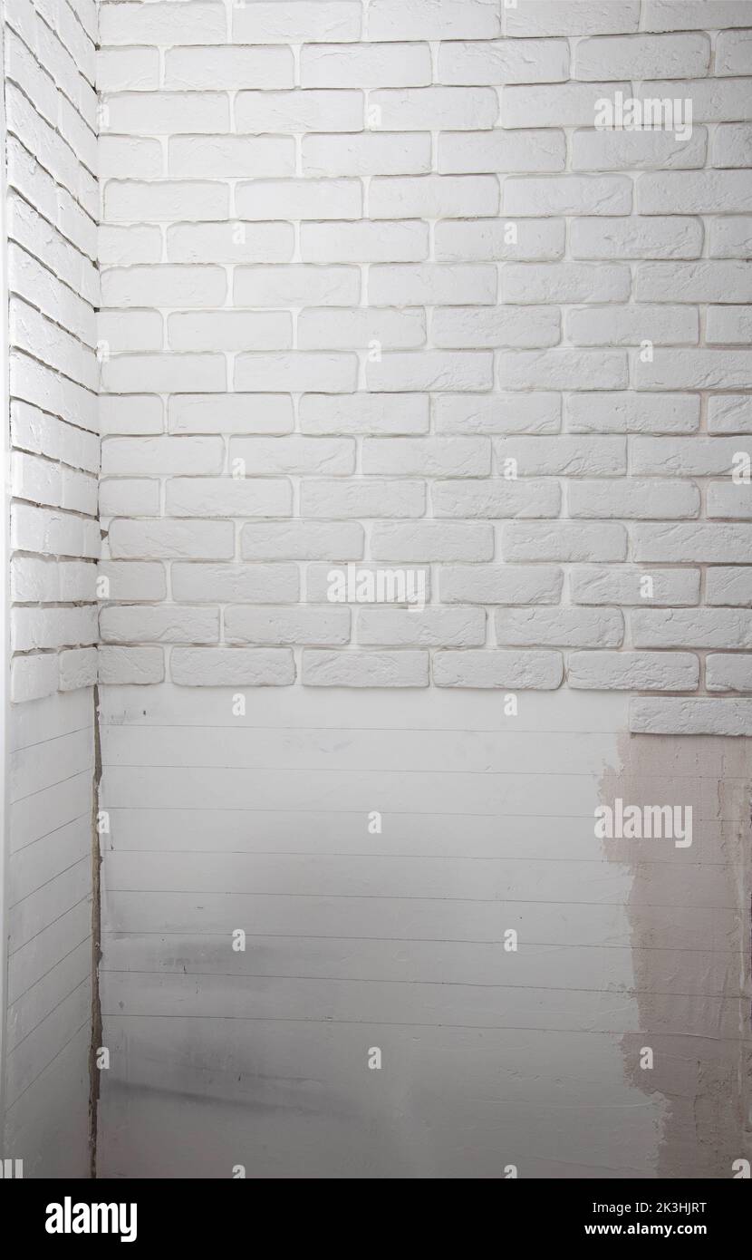 White wall made of decorative stone in the form of a brick. Laying ...