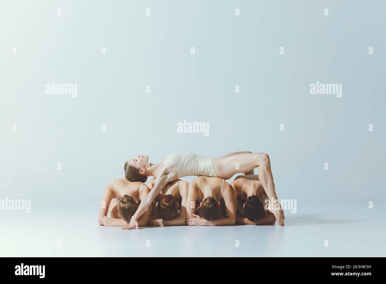 Group of young girls, ballet dancers performing, posing isolated over ...