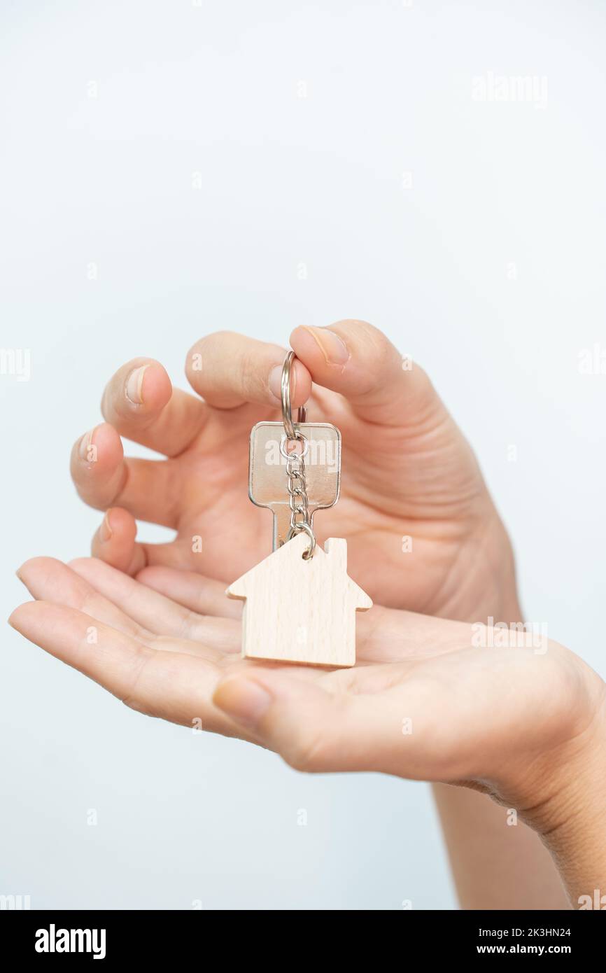 Close-up of beautiful hands of a woman with the new home keys. Keychain ...
