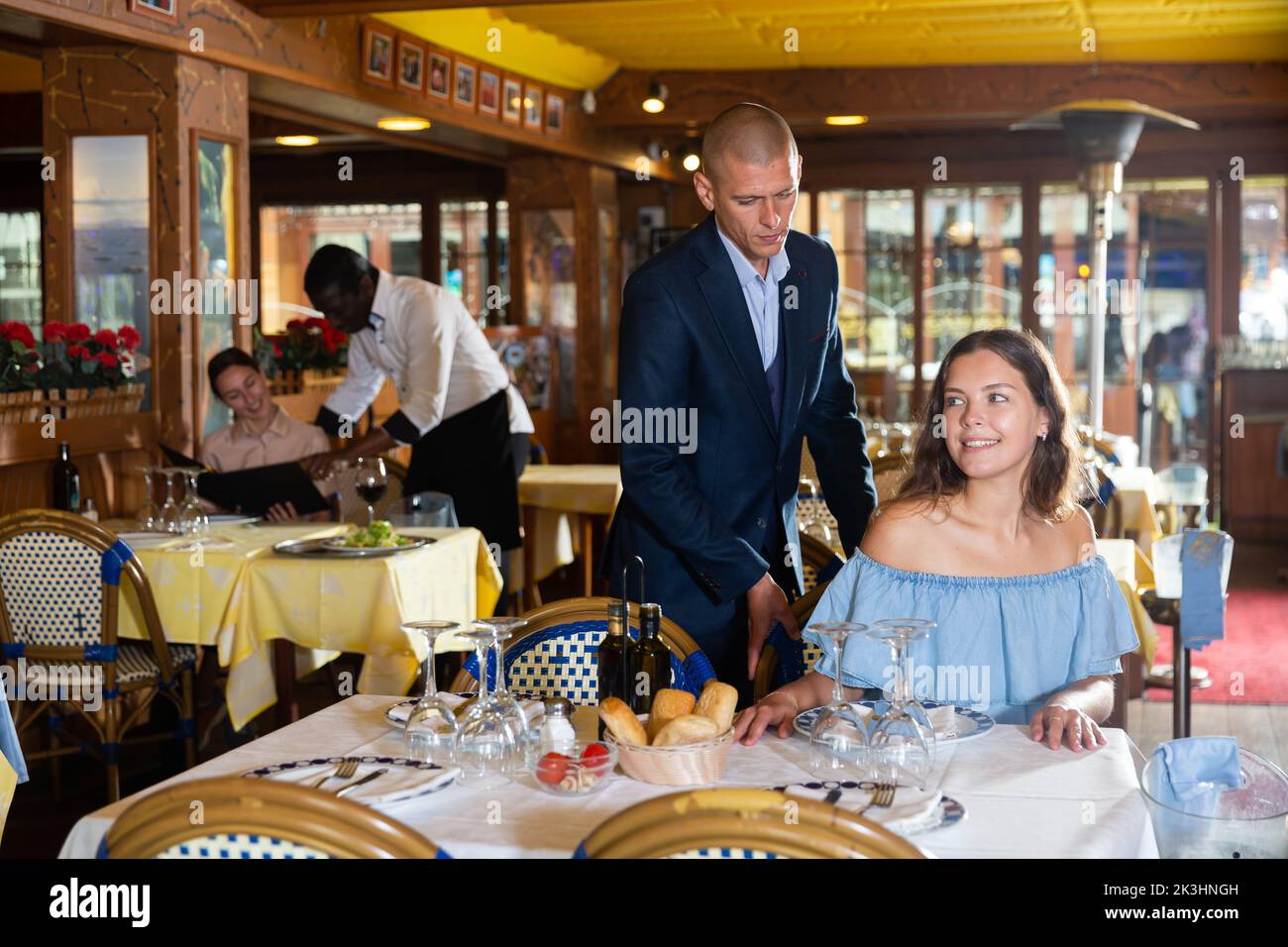 Portrait of a young elegant couple visiting restaurant Stock Photo - Alamy