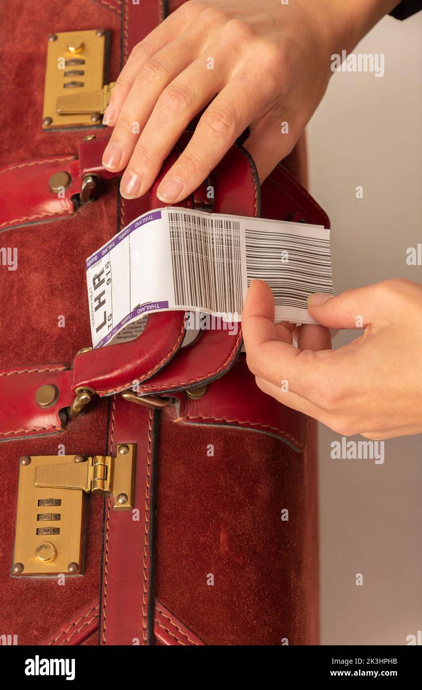 Enngland, UK. 2022. Airline luggage destination identity tag being ... Enngland, UK. 2022. Airline luggage destination identity tag being ...