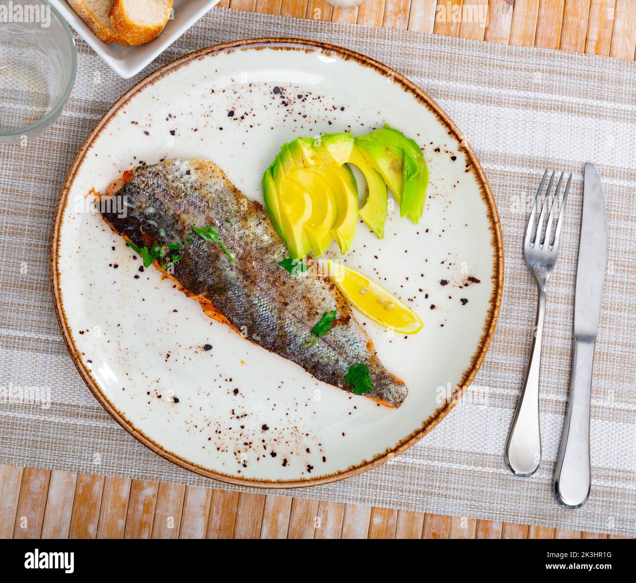 Fried trout fillet served with avocado is healthy dish in kitchen Stock ...