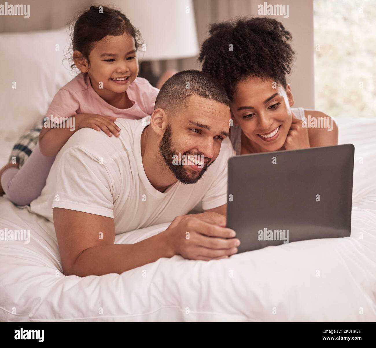 Brazilian family, laptop and girl bonding in house, home or hotel bedroom for movie streaming ...