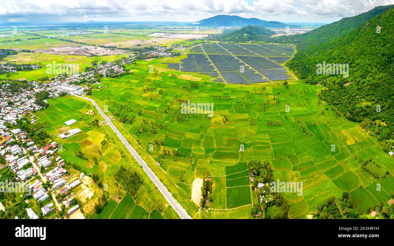Rice fields interspersed with solar power fields in the morning, a ...
