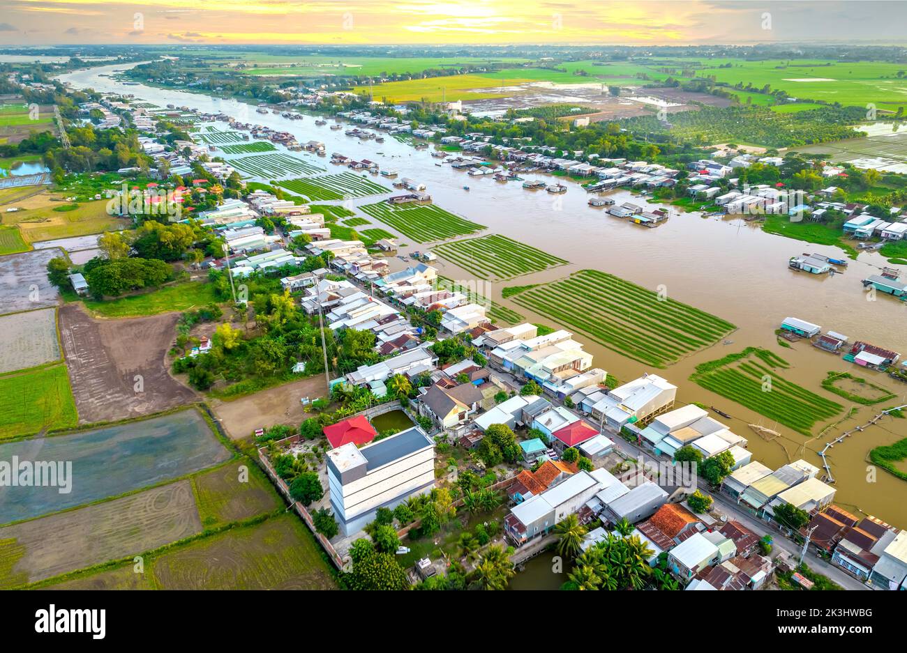 Floating village along Hau river over Vietnam border area, aerial view. The river basin contains ...