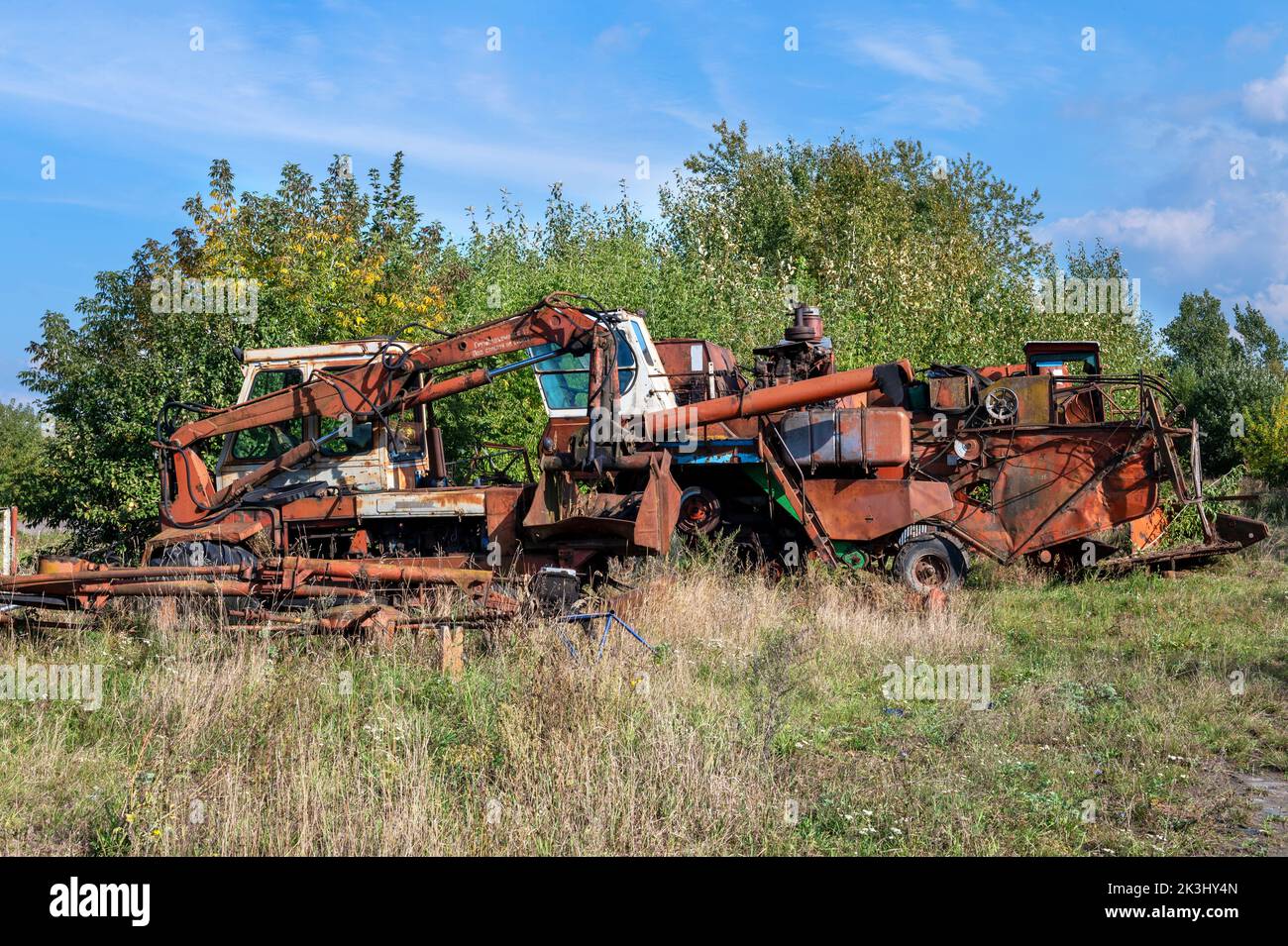 Old rusty agricultural machinery. Abandoned harvester, tractor Stock ...