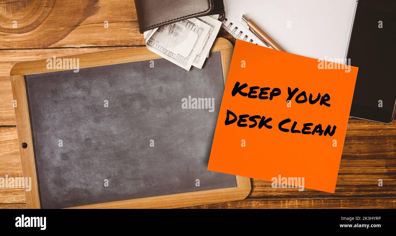 Composite of keep your desk clean on sticky note with slate, notepad ...