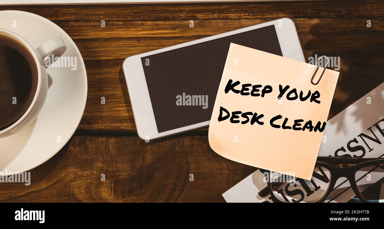 Composite of keep your desk clean on sticky note with cellphone and ...