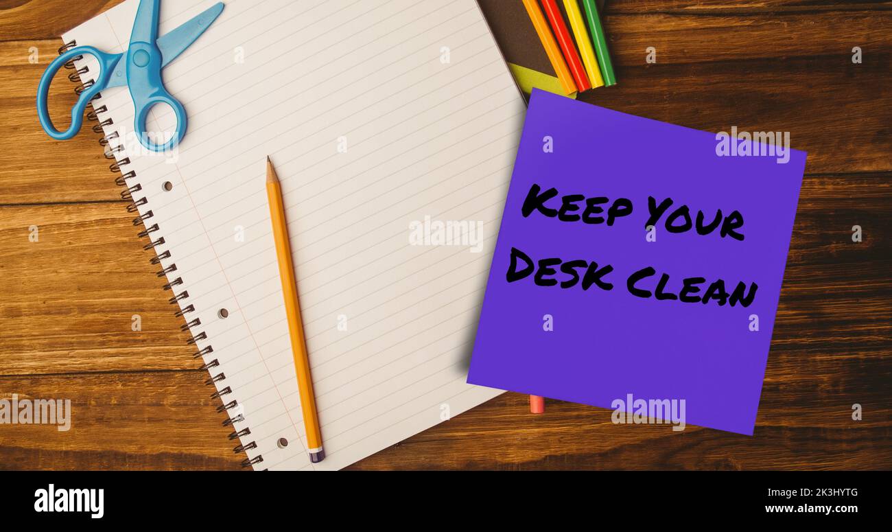 Composite of keep your desk clean on sticky note with pencil, scissors ...