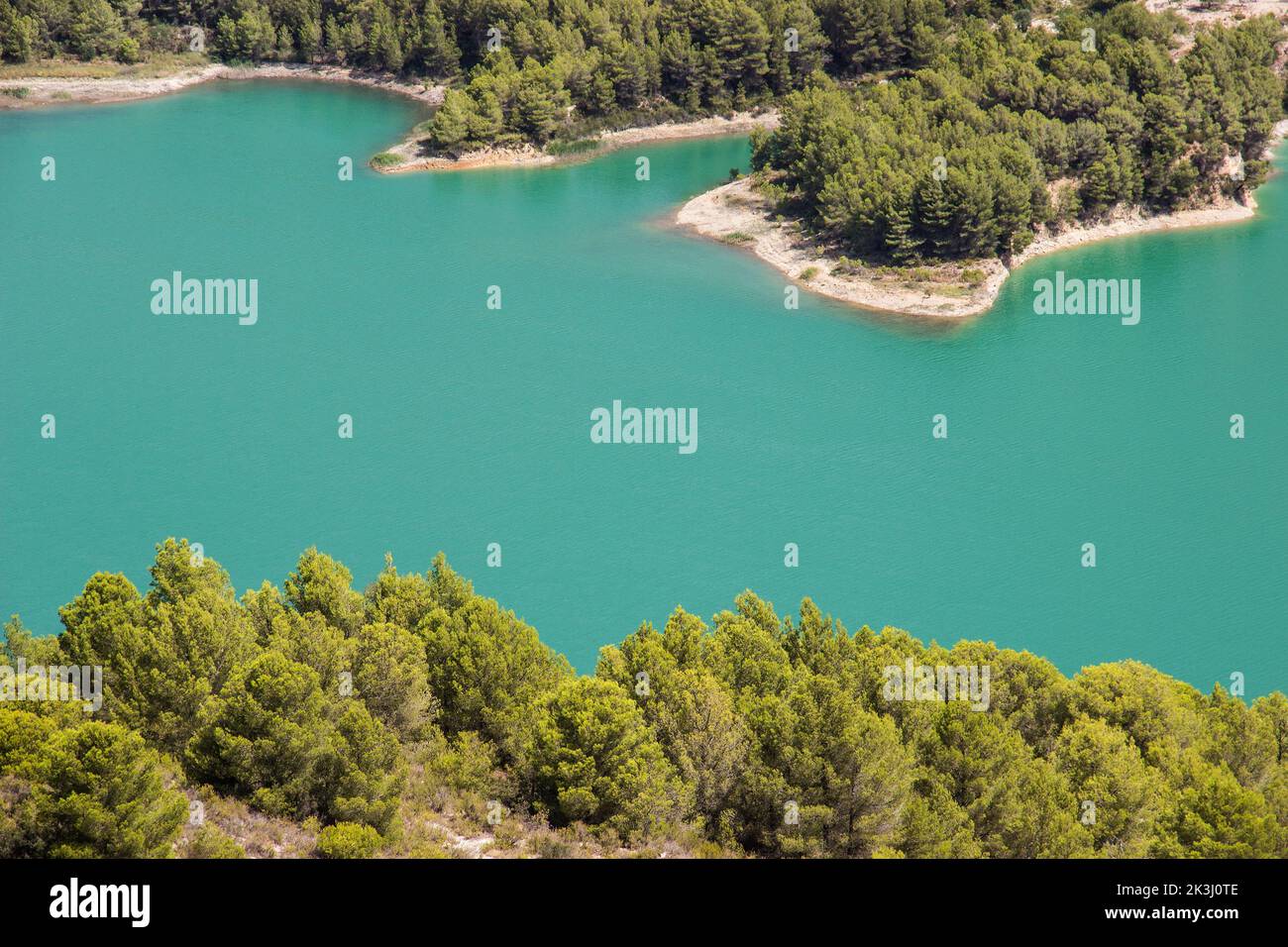 An azure lake between forests in the daytime Stock Photo - Alamy