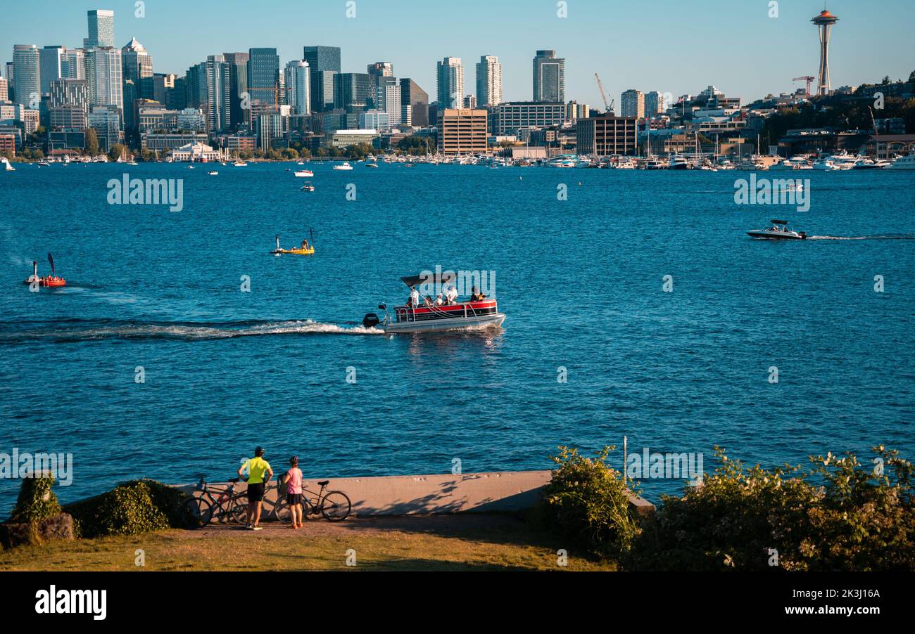The boasts on the blue water with the Seattle skyline in the background ...